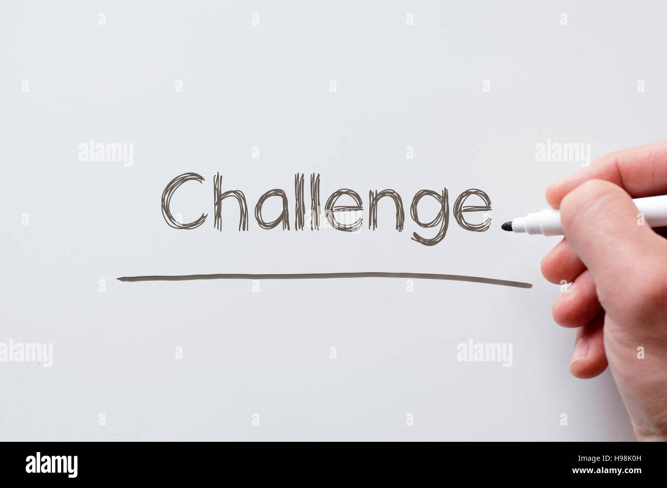 Human hand writing challenge on whiteboard Stock Photo - Alamy