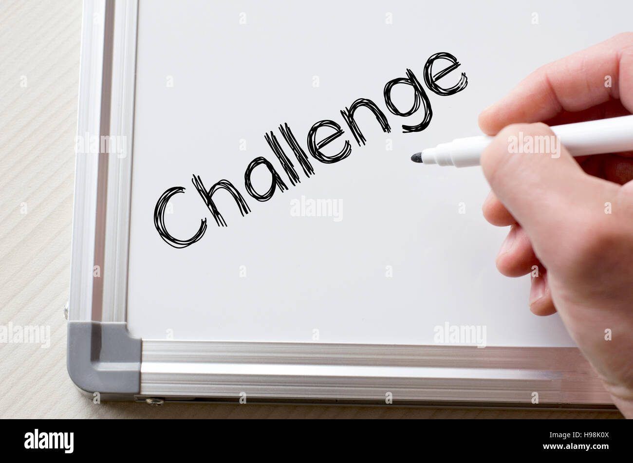 Human hand writing challenge on whiteboard Stock Photo - Alamy