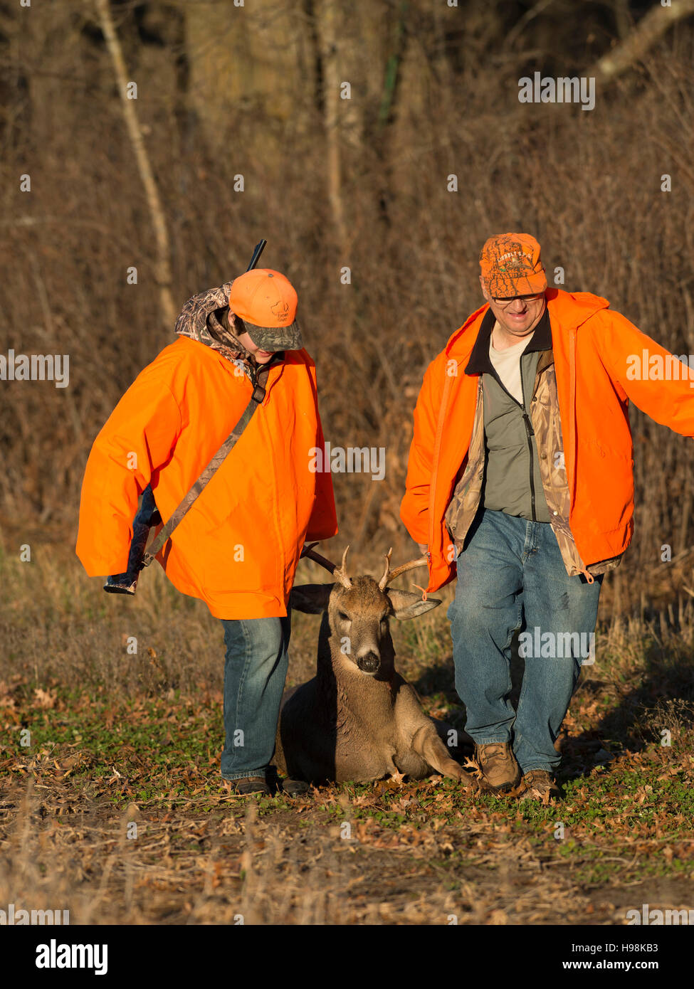 Grandfather and grandson out deer hunting Stock Photo - Alamy