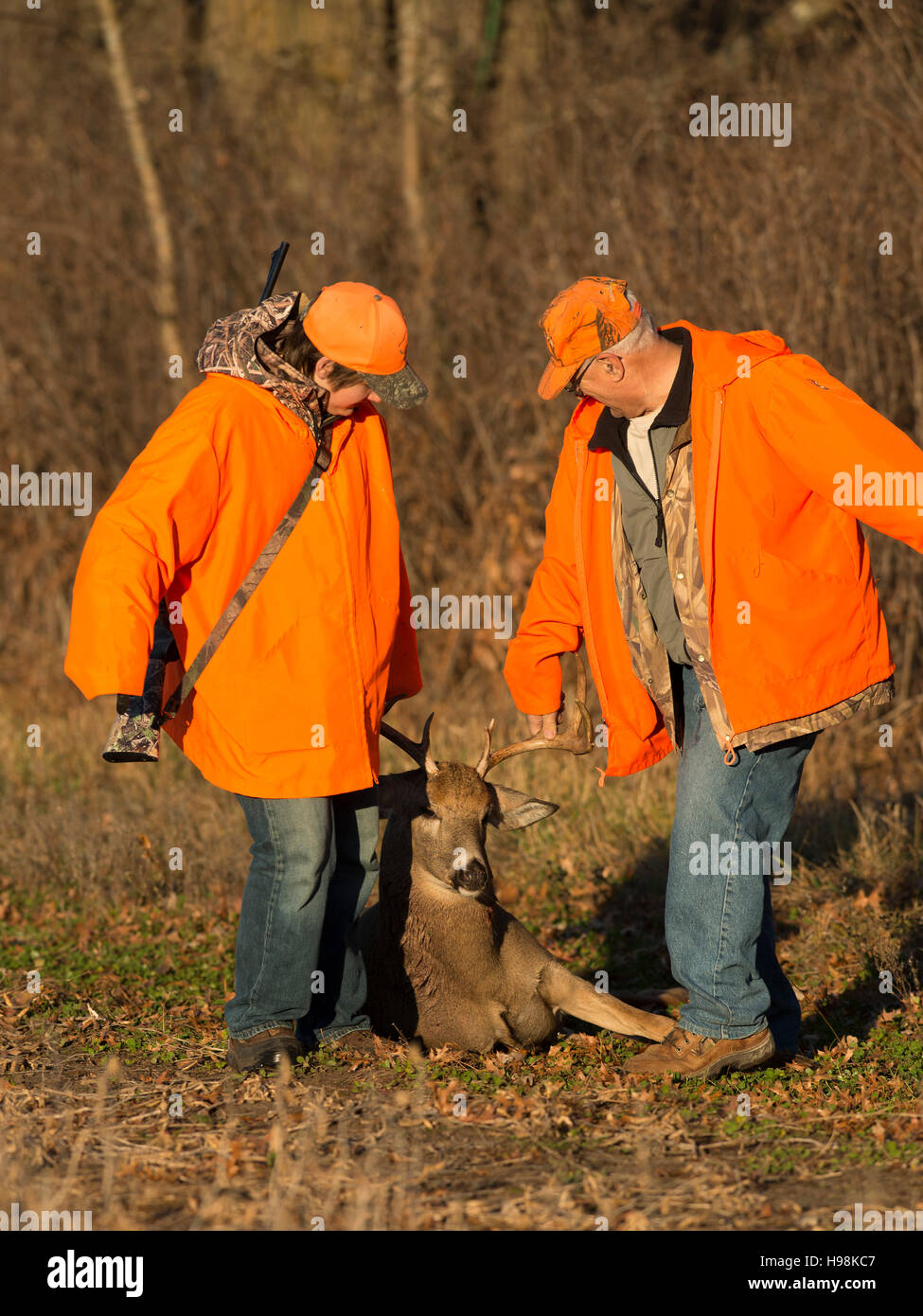 Grandfather and grandson out deer hunting Stock Photo - Alamy