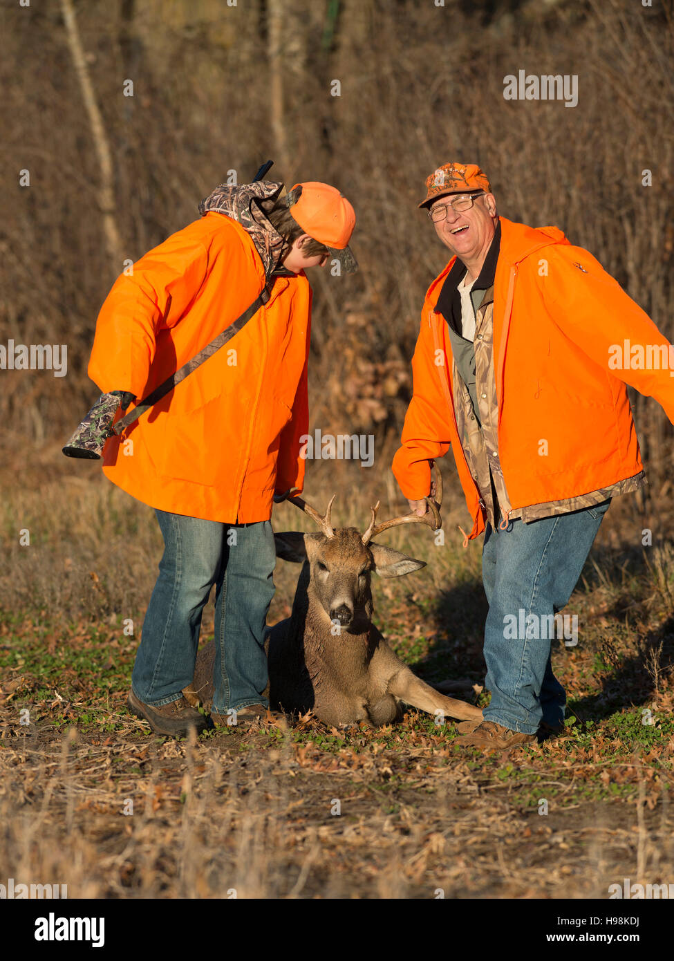 Grandfather and grandson out deer hunting Stock Photo - Alamy