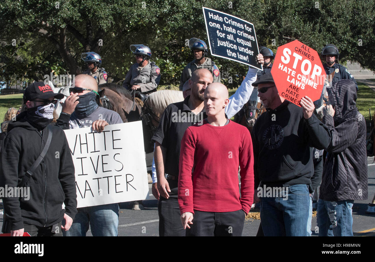 White male masked marchers carry signs protesting hate crime laws at ...