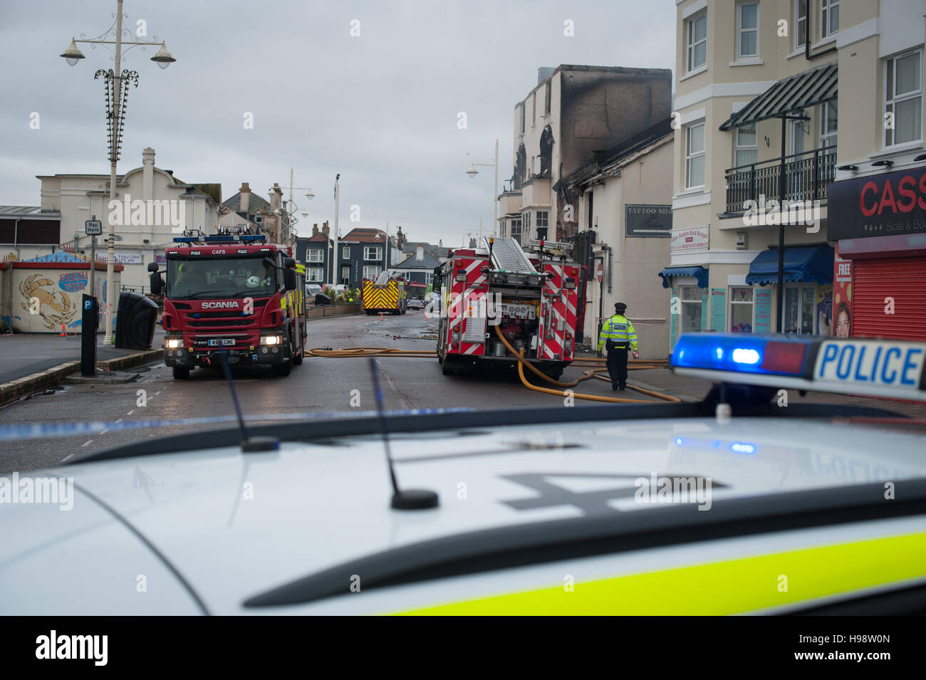 A police officer, fire engines and a police car at the scene of a major ...