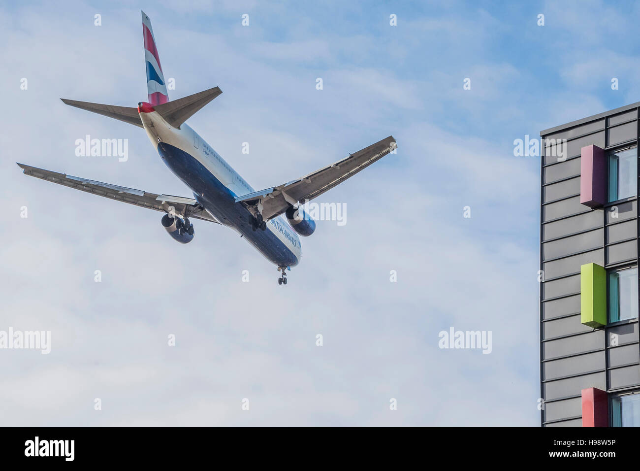 London, UK. 19th November, 2016. A plane comes in to land past a ...