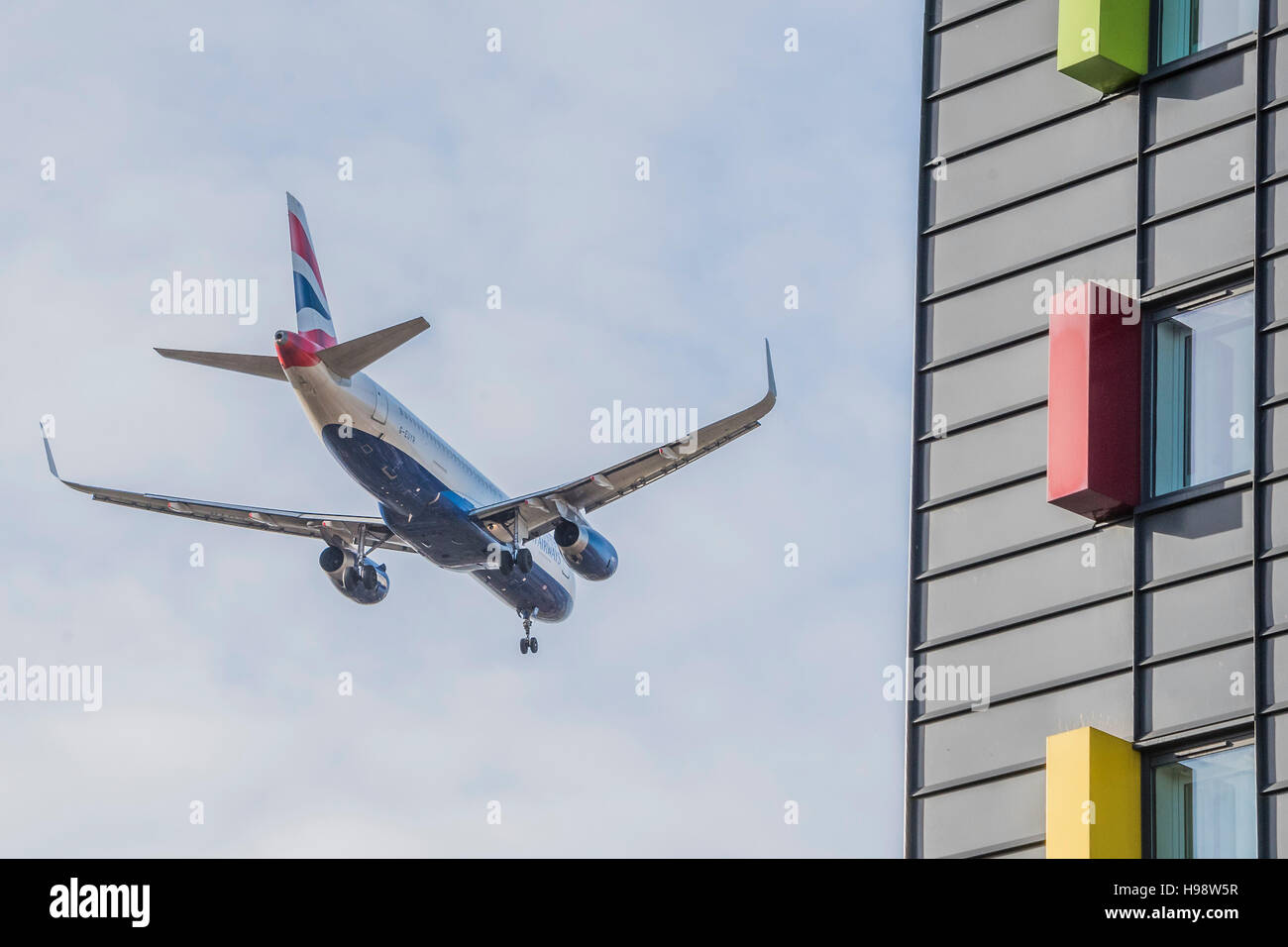 London, UK. 19th November, 2016. A plane comes in to land past a ...