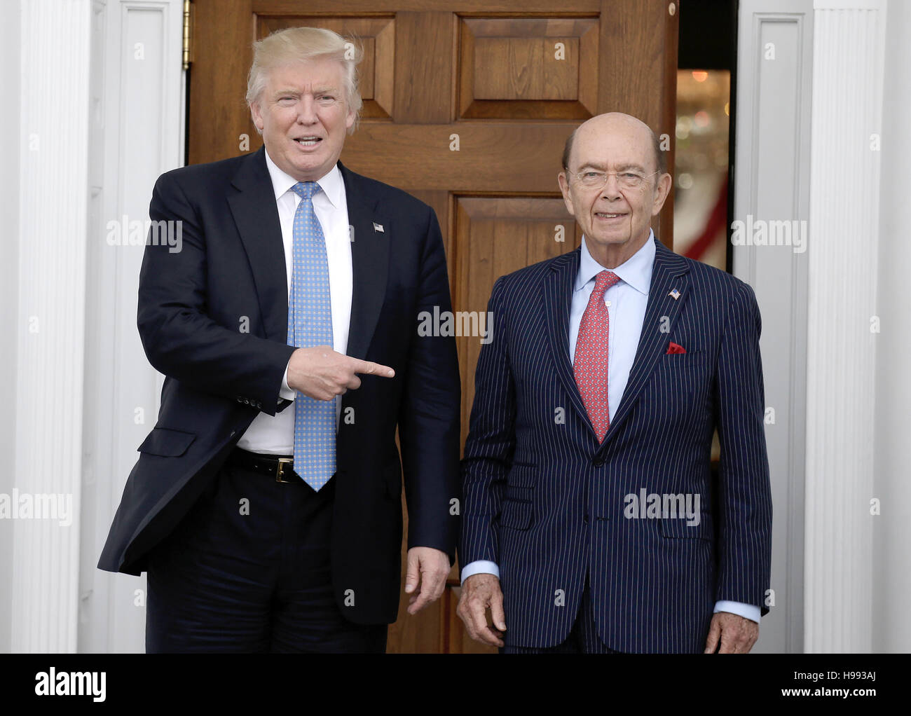 United States President-elect Donald Trump (L) gestures at investor ...