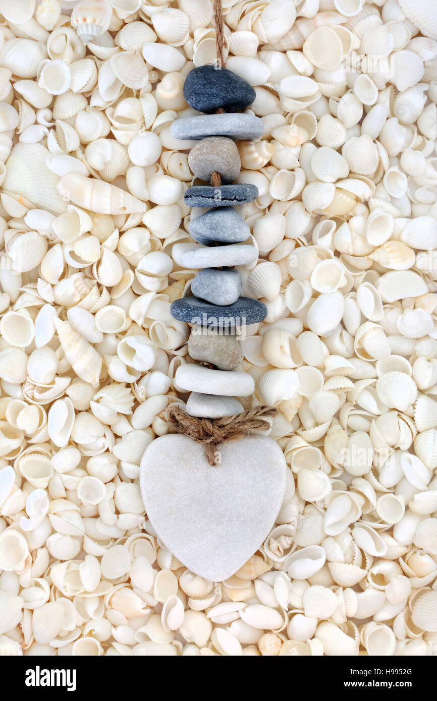 Heart and pebble mobile on white seashell abstract background Stock ...