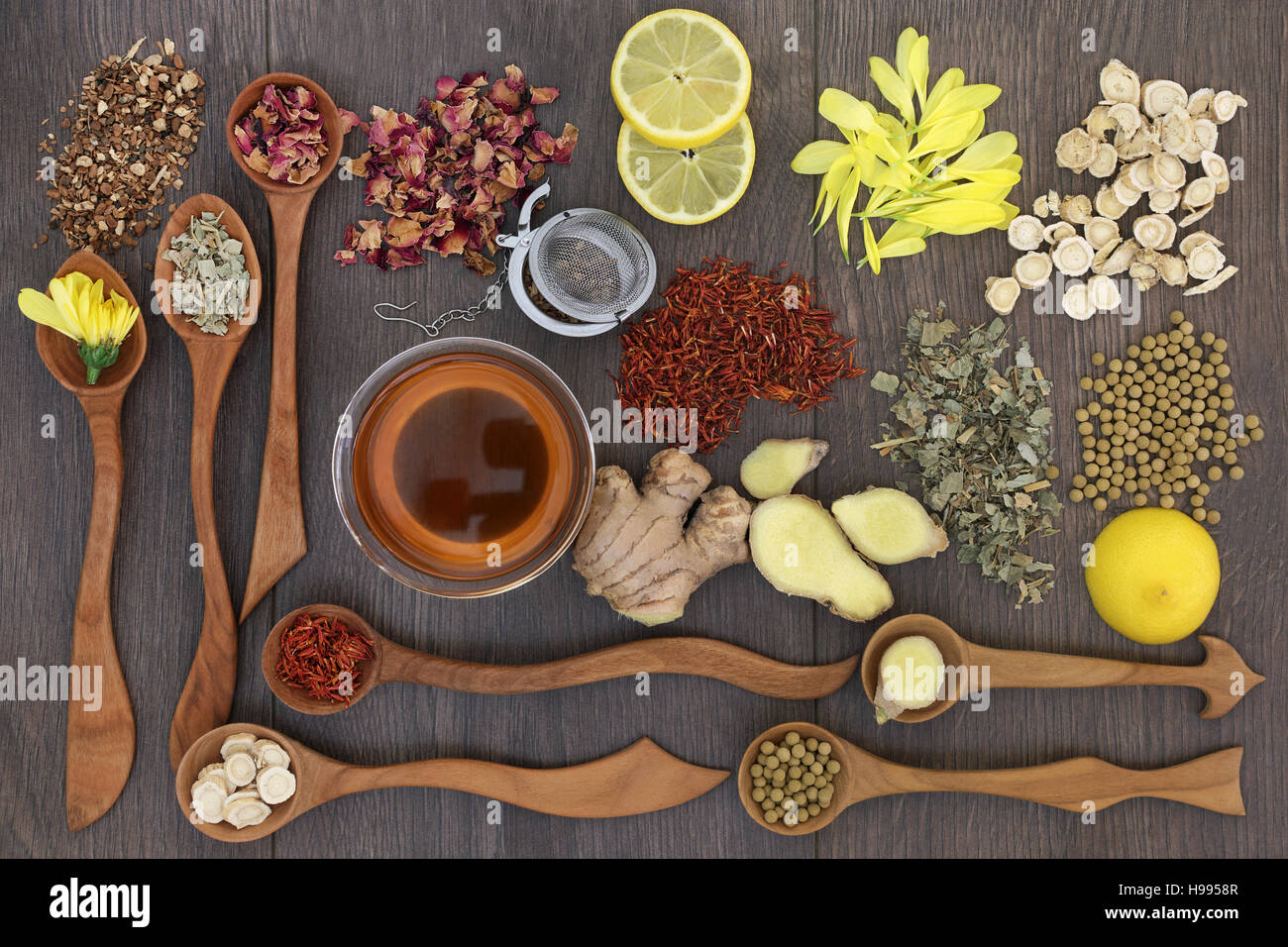 Healthy herbal teas in wooden spoons with glass tea cup and strainer ...