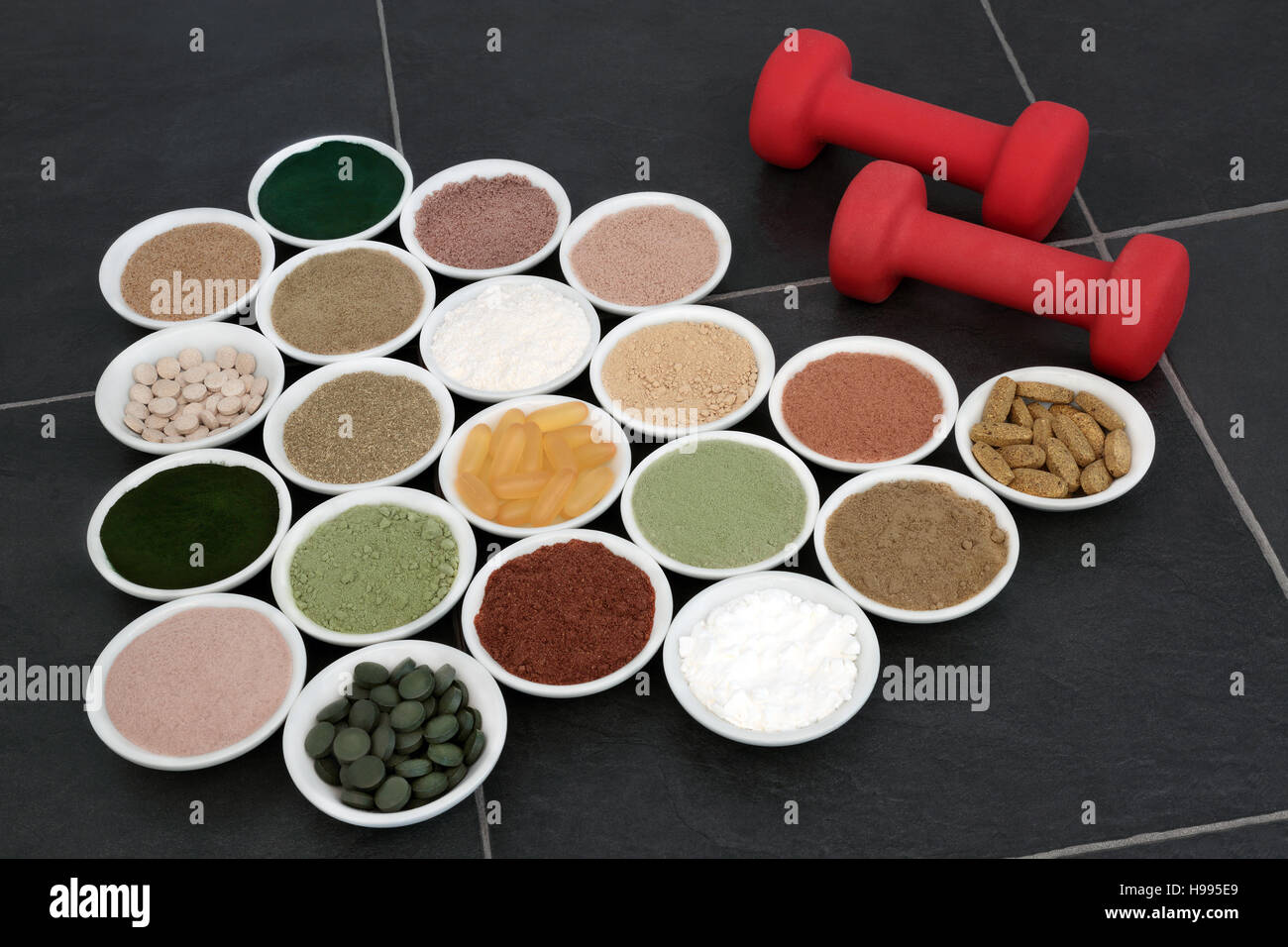 Body building powders and vitamin pill supplements with dumbbell ...