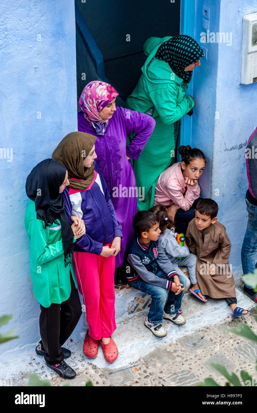 A Moroccan Family Watching The Life In Their Street From Their Front ...
