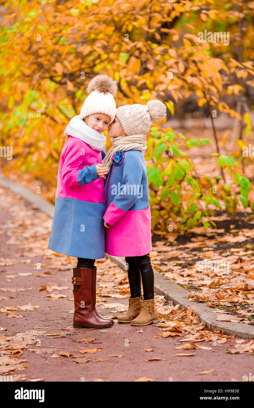Little adorable girls playing in beautiful autumn park outdoor Stock ...