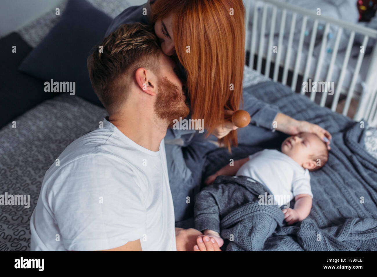 Young parents giving of attention to their baby Stock Photo - Alamy