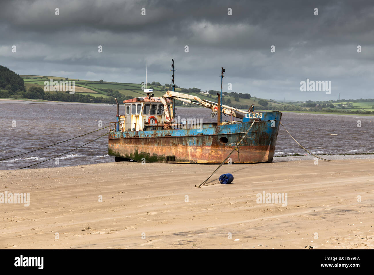 an old rusty boat on the beach of a river Stock Photo - Alamy