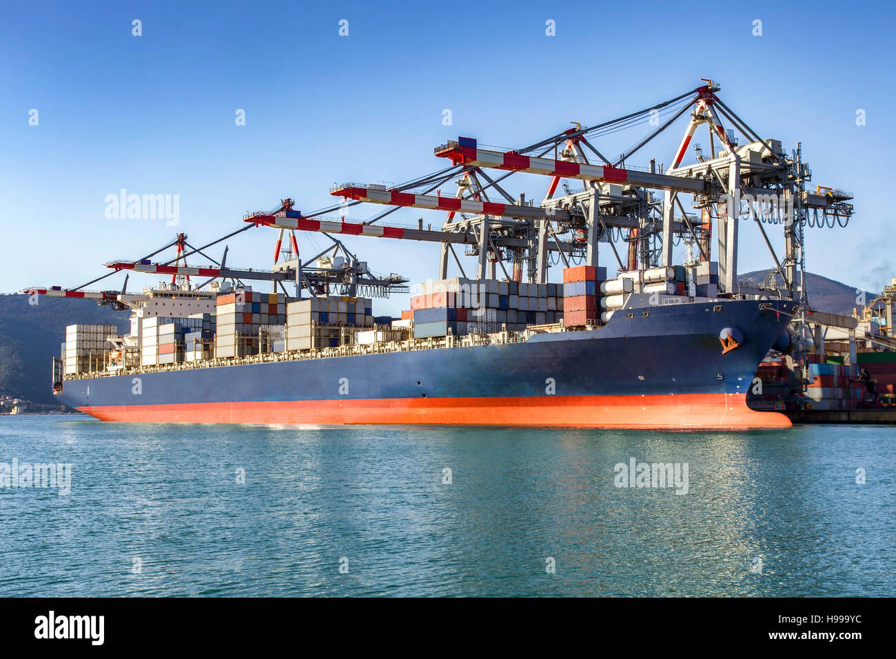 loading cargo ship in port Stock Photo - Alamy
