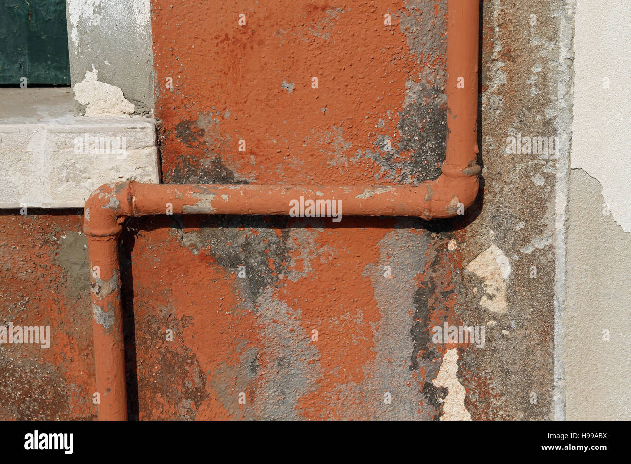 gas pipe on the peeling wall of a very old house Stock Photo - Alamy