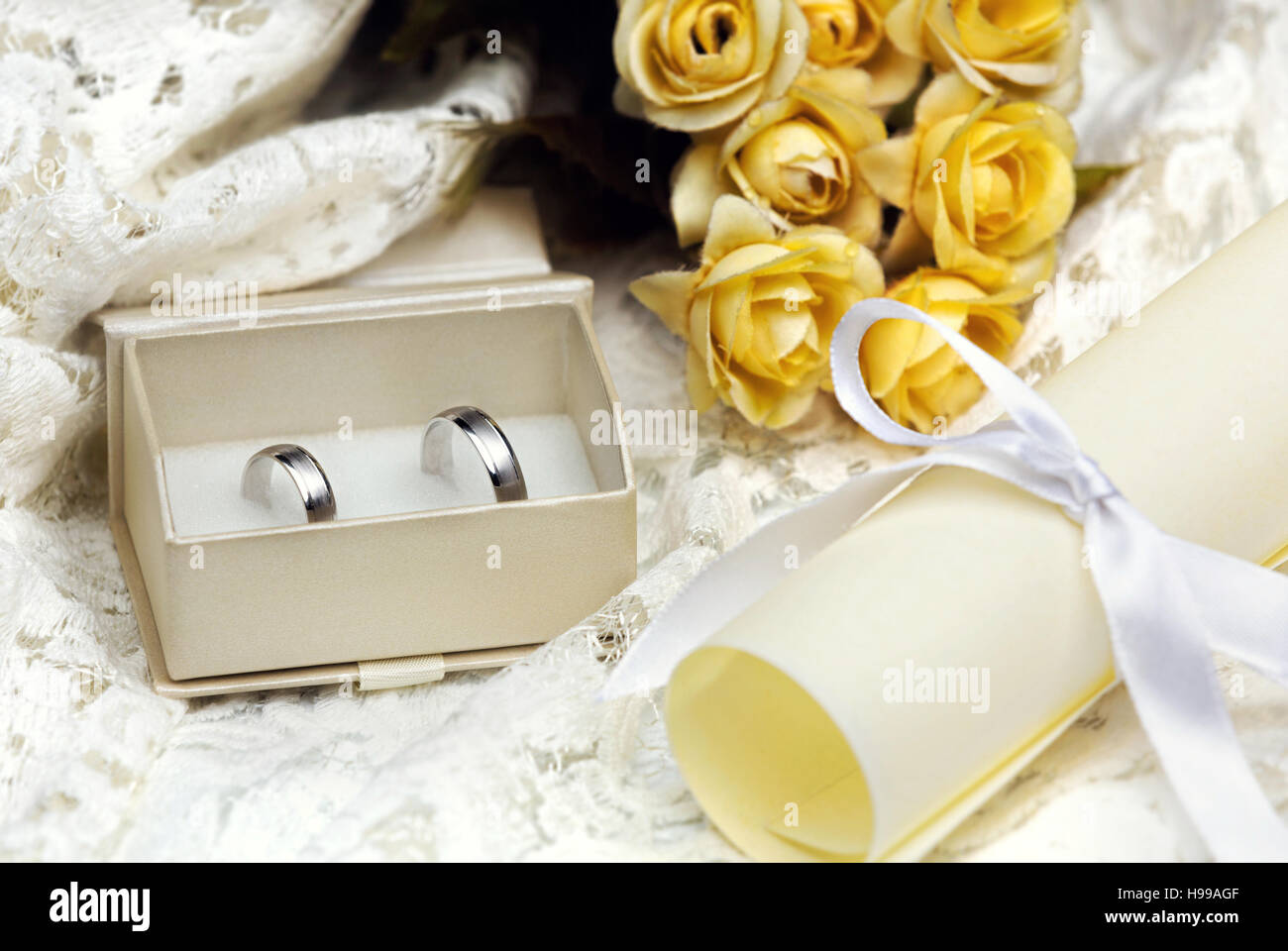 Wedding rings set next to wedding invitation Stock Photo - Alamy