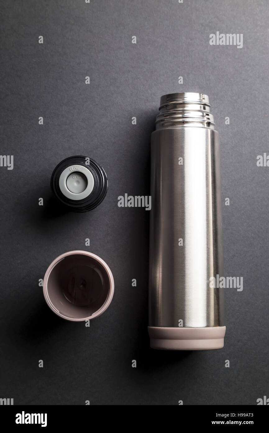 Metallic thermos over black background presentation Stock Photo - Alamy