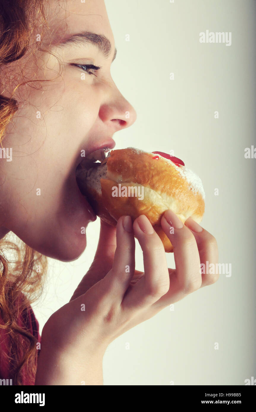 Woman eating donut hi-res stock photography and images - Alamy