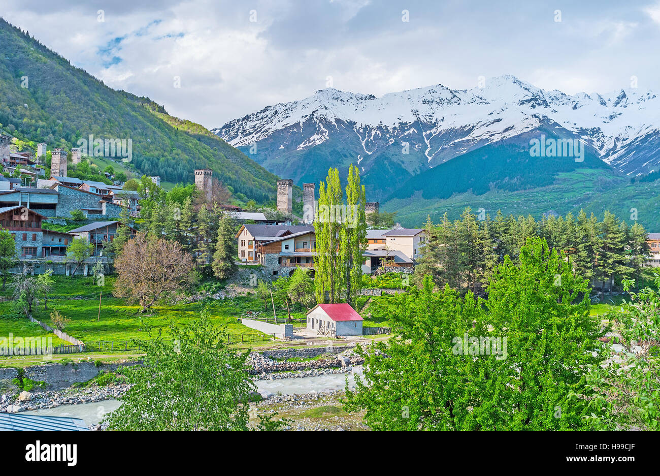 The sunny Mestiacchala river valley overlooks shady slopes of ...