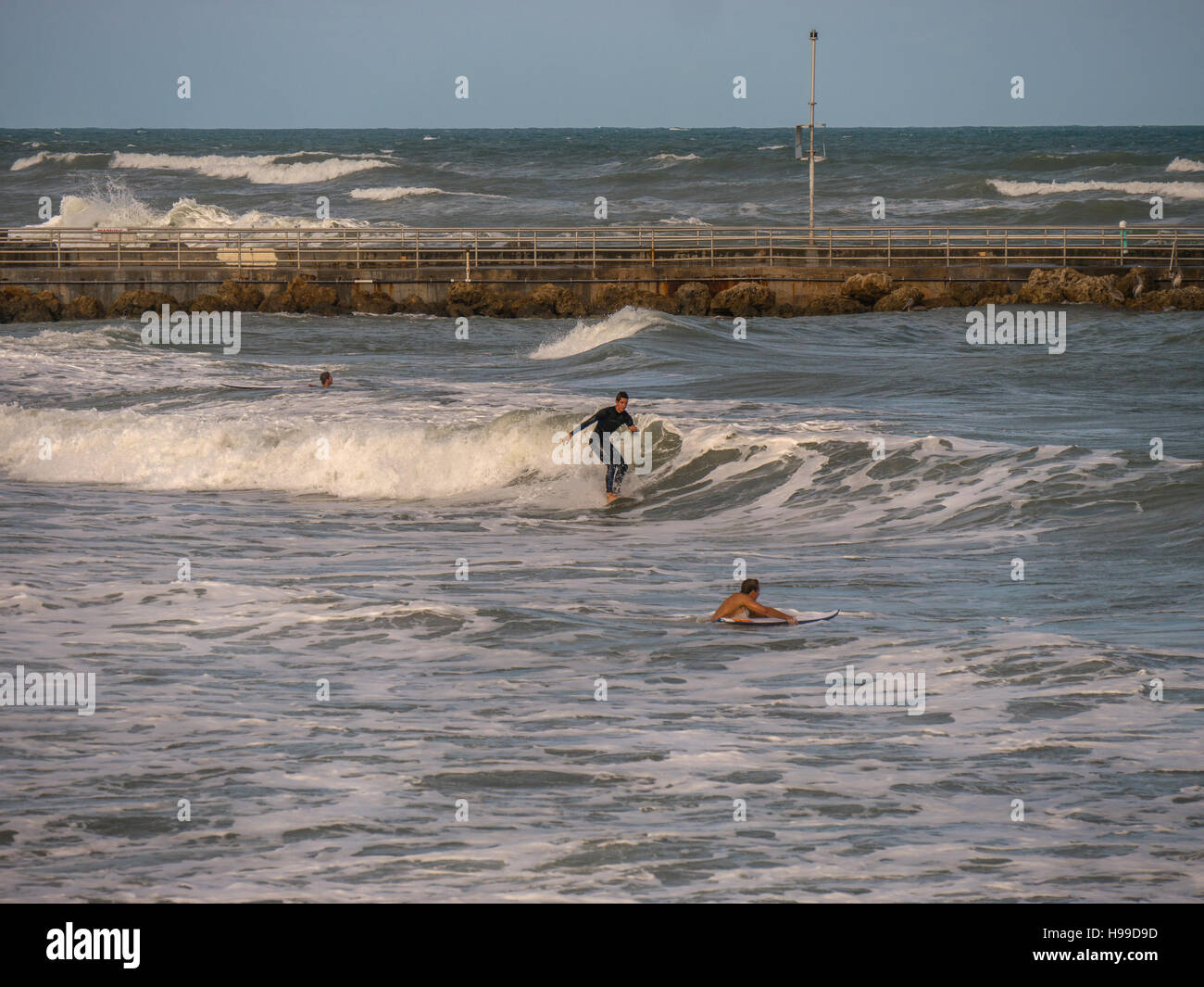 People surfing in the waves on Jupiter Beach in Florida Stock Photo - Alamy