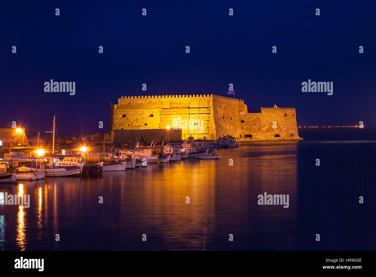 The Venetian fortress of Castello a Mare gets golden reflection in dark ...