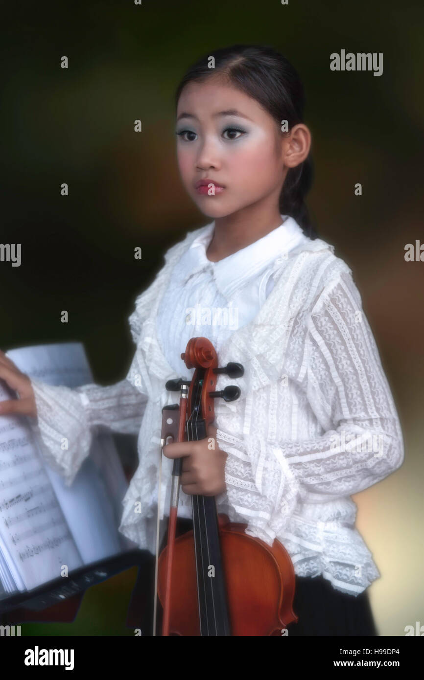 Young violinist. Classical child musician pictured with her violin ...