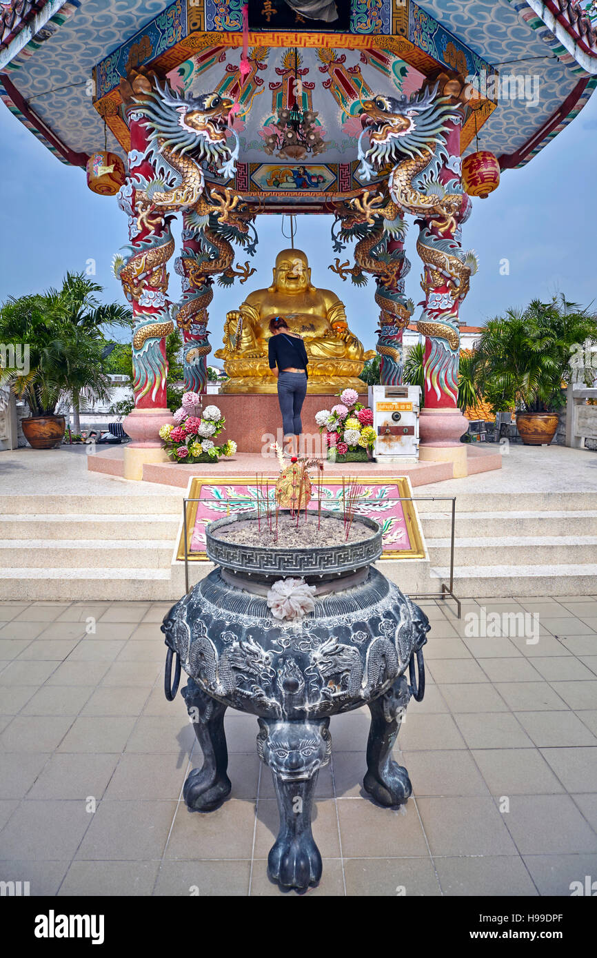 Ornate Chinese pagoda shrine housing a laughing golden Buddha. Na Klua ...