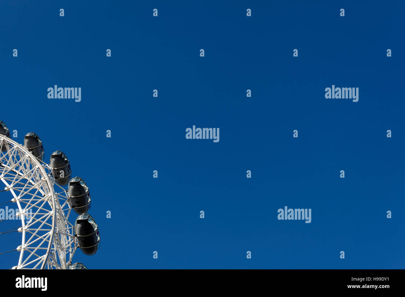 Four capsules of the London Eye shot against a clear deep blue sky ...