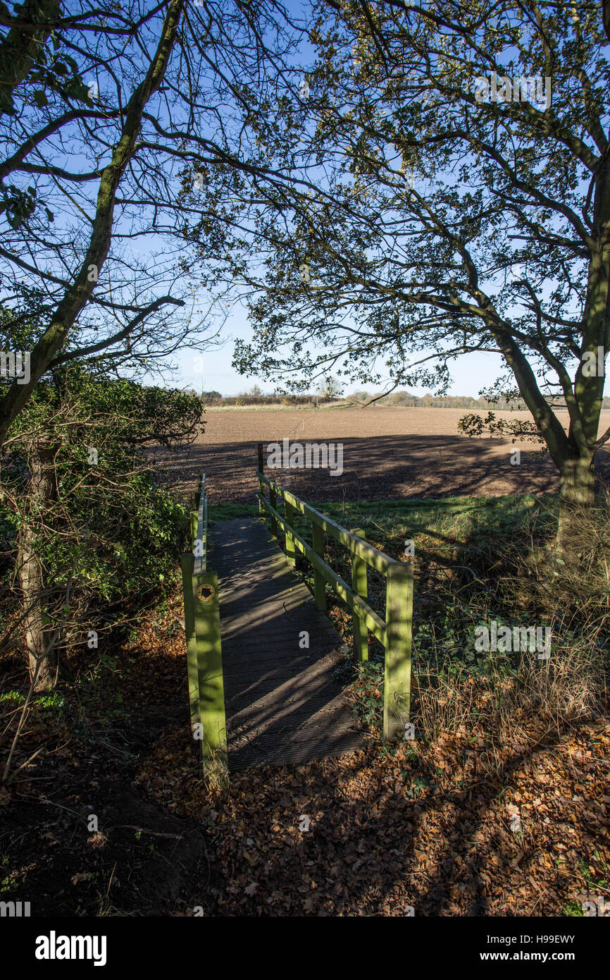 A wooden bridge over a small stream in english countryside Stock Photo ...