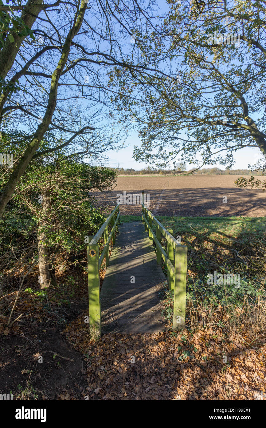 A wooden bridge over a small stream in english countryside Stock Photo ...