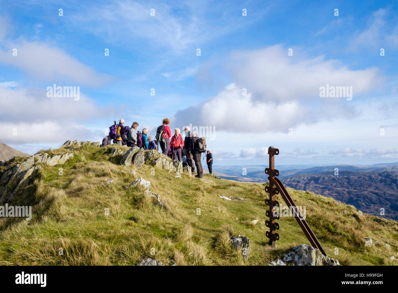 Group of hikers on Yr Aran summit in mountains of Snowdonia National ...