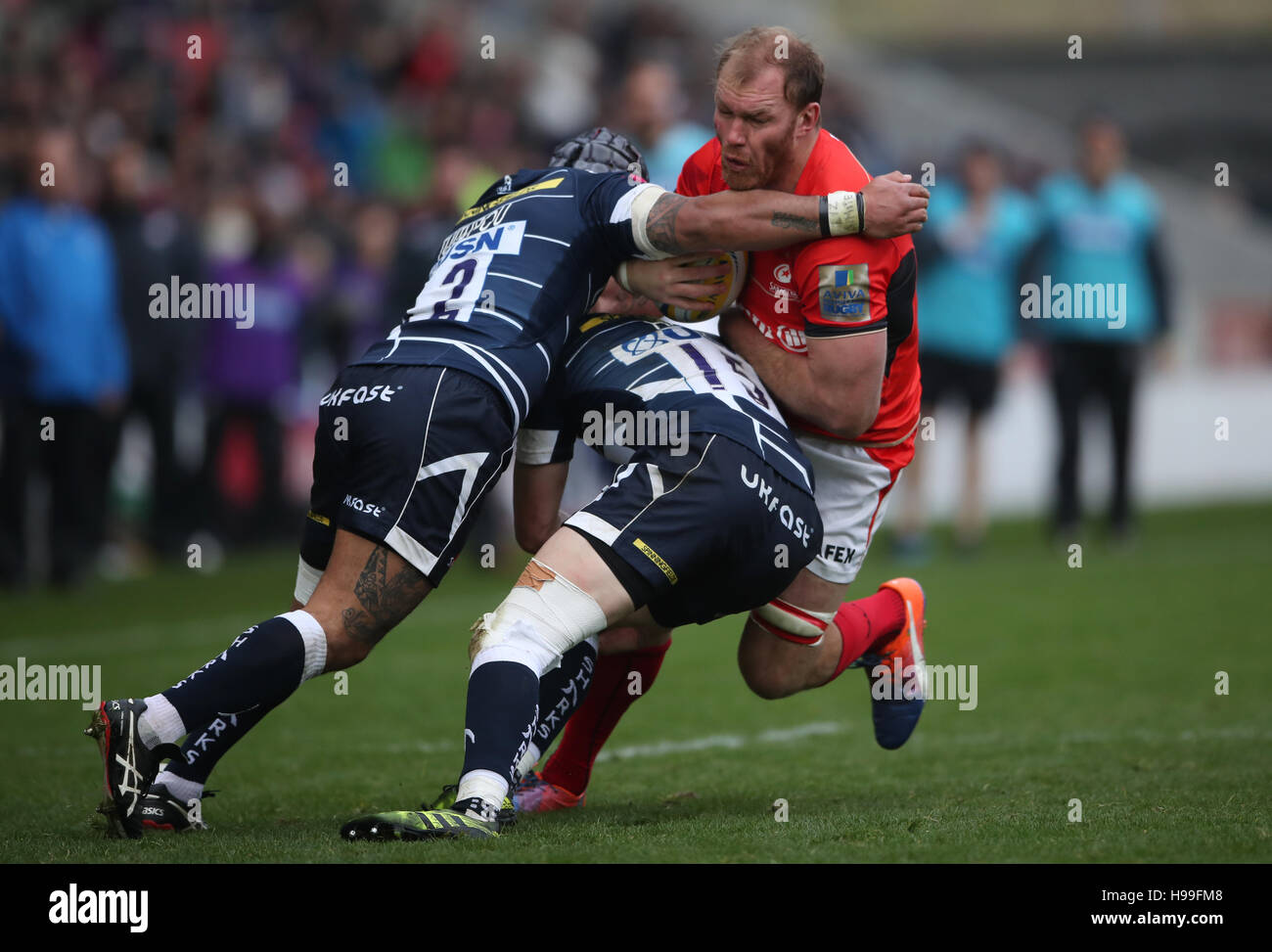 Saracens' Schalk Burger tackled by Sale Sharks' Mike Haley (15) and Sam ...