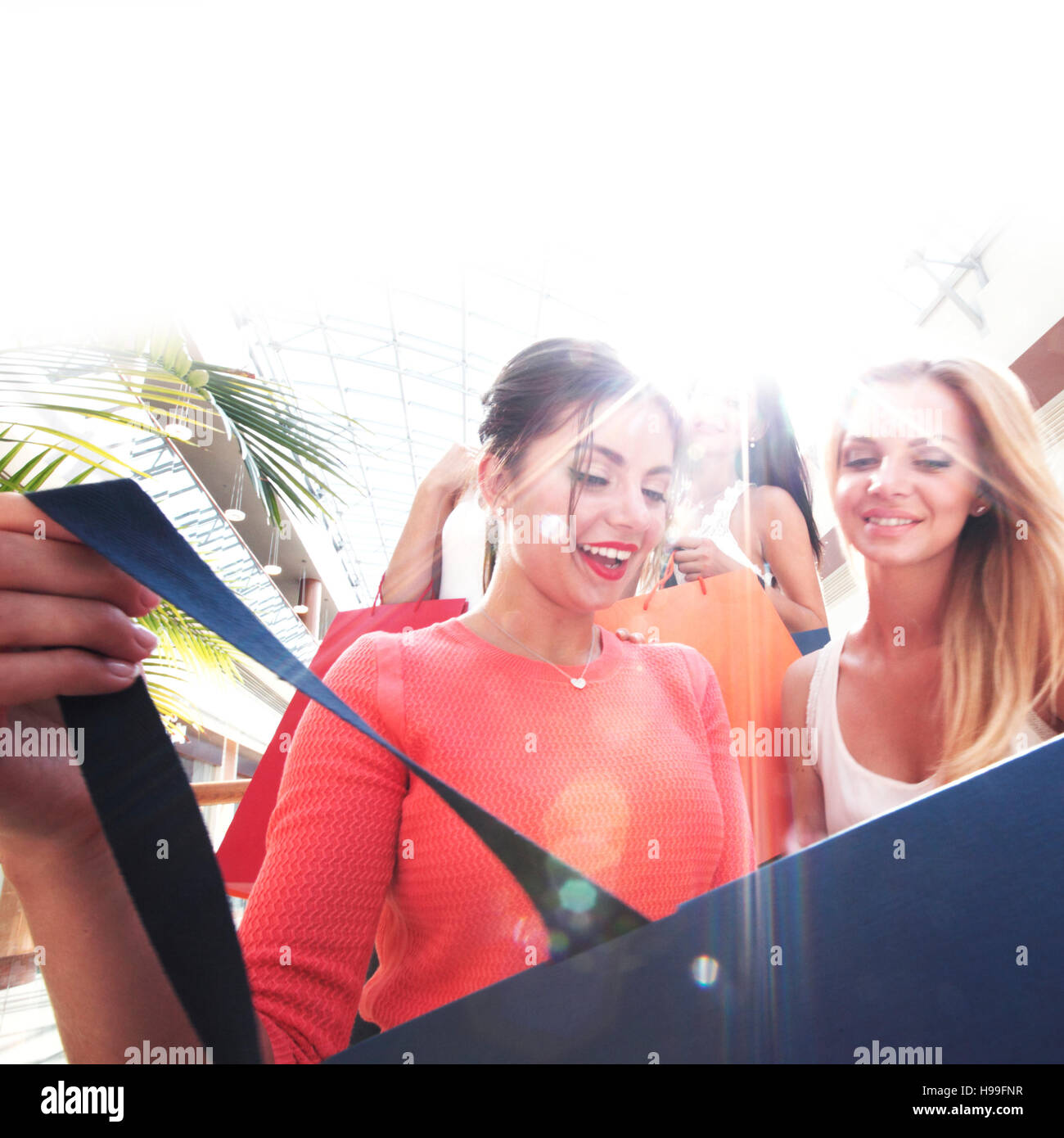 Beautiful young women shopping at mall Stock Photo - Alamy