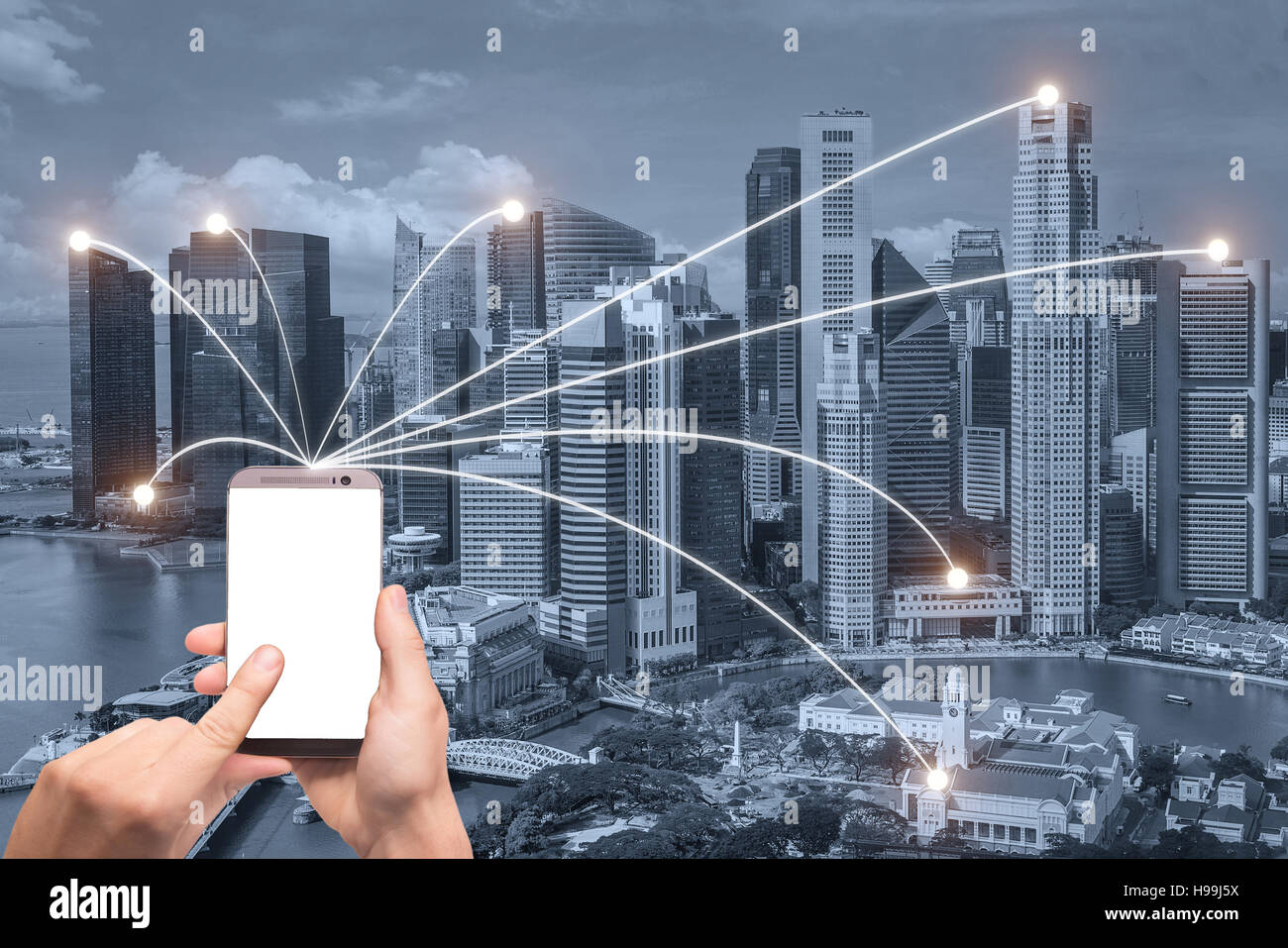 Hand holding smart phone and Singapore city with network connection ...