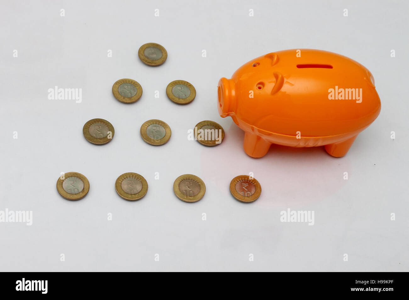 Piggy bank and ten rupee coin of India. Pyramid pattern design Stock ...