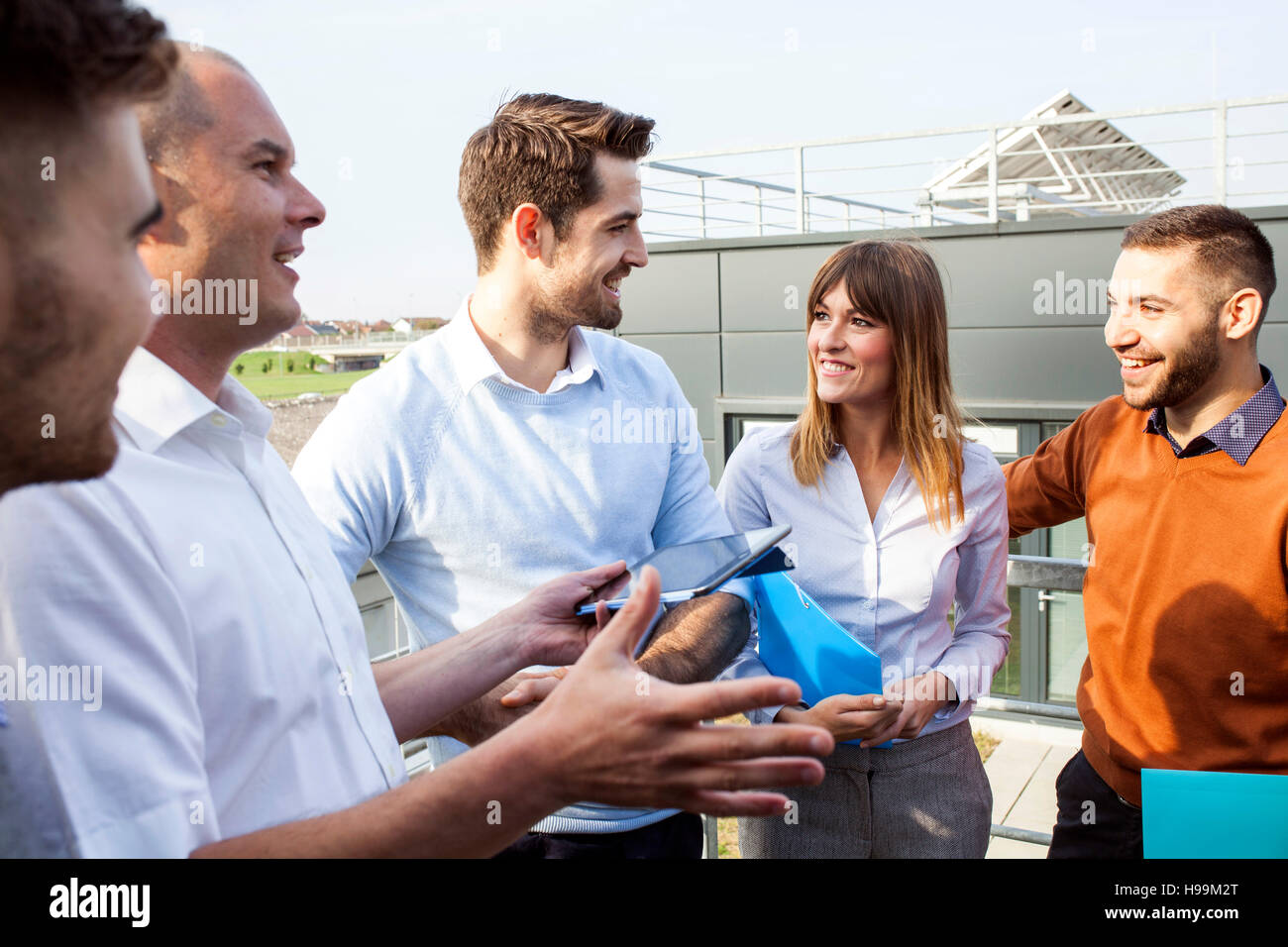 Group of business people talking outdoors Stock Photo - Alamy