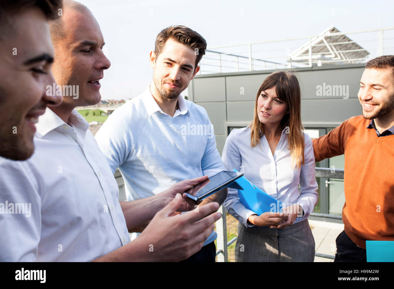 Group of business people talking outdoors Stock Photo - Alamy