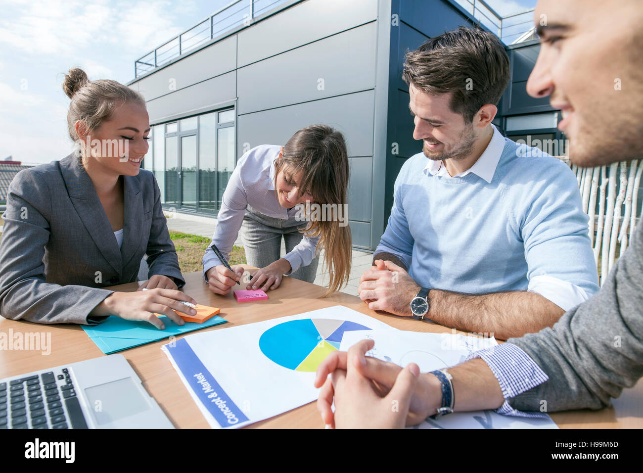 Group of business people working on rooftop terrace Stock Photo - Alamy