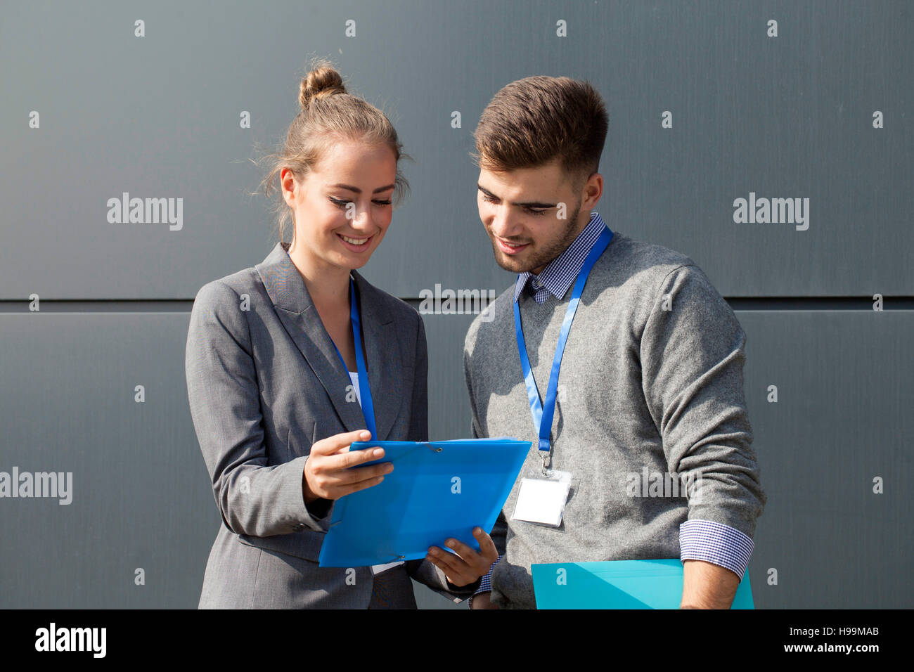 Two business colleagues talking over document Stock Photo - Alamy