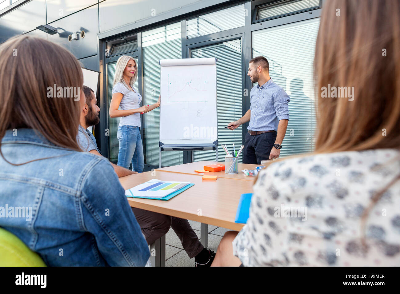 Business people giving presentation in workshop Stock Photo - Alamy