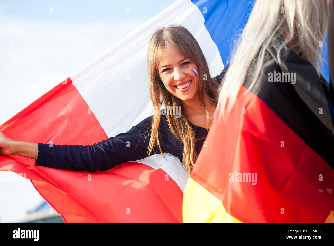 Female soccer fans waving flags Stock Photo - Alamy