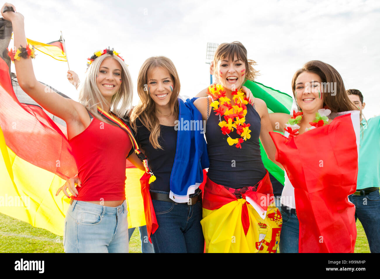 Group of soccer fans celebrating on soccer field Stock Photo - Alamy