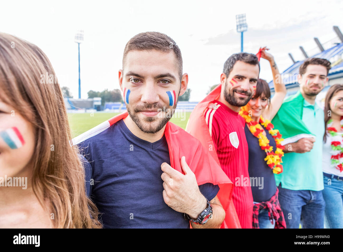 Group of soccer fans on soccer field Stock Photo - Alamy