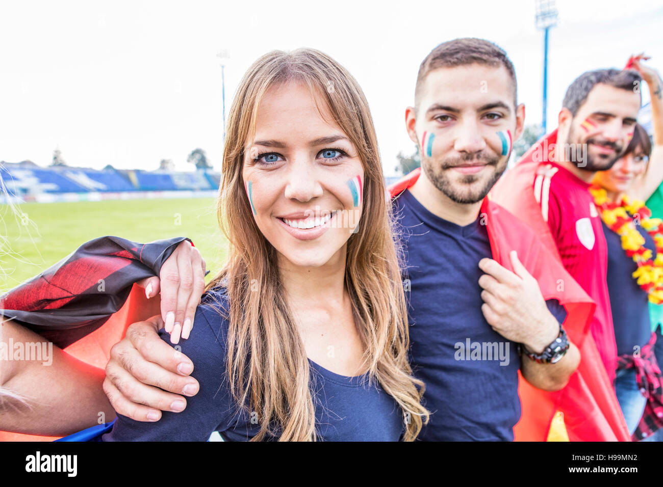 Group of soccer fans on soccer field Stock Photo - Alamy