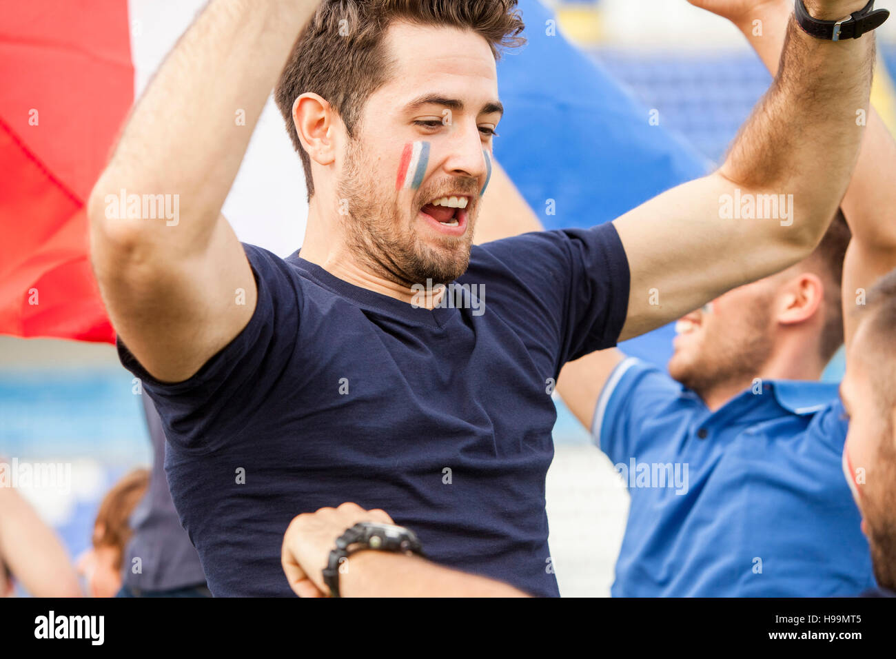 Portrait of male soccer fan celebrating in stadium Stock Photo - Alamy
