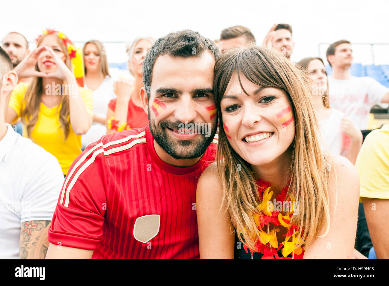 Portrait of couple with face paint in Spanish colors Stock Photo - Alamy