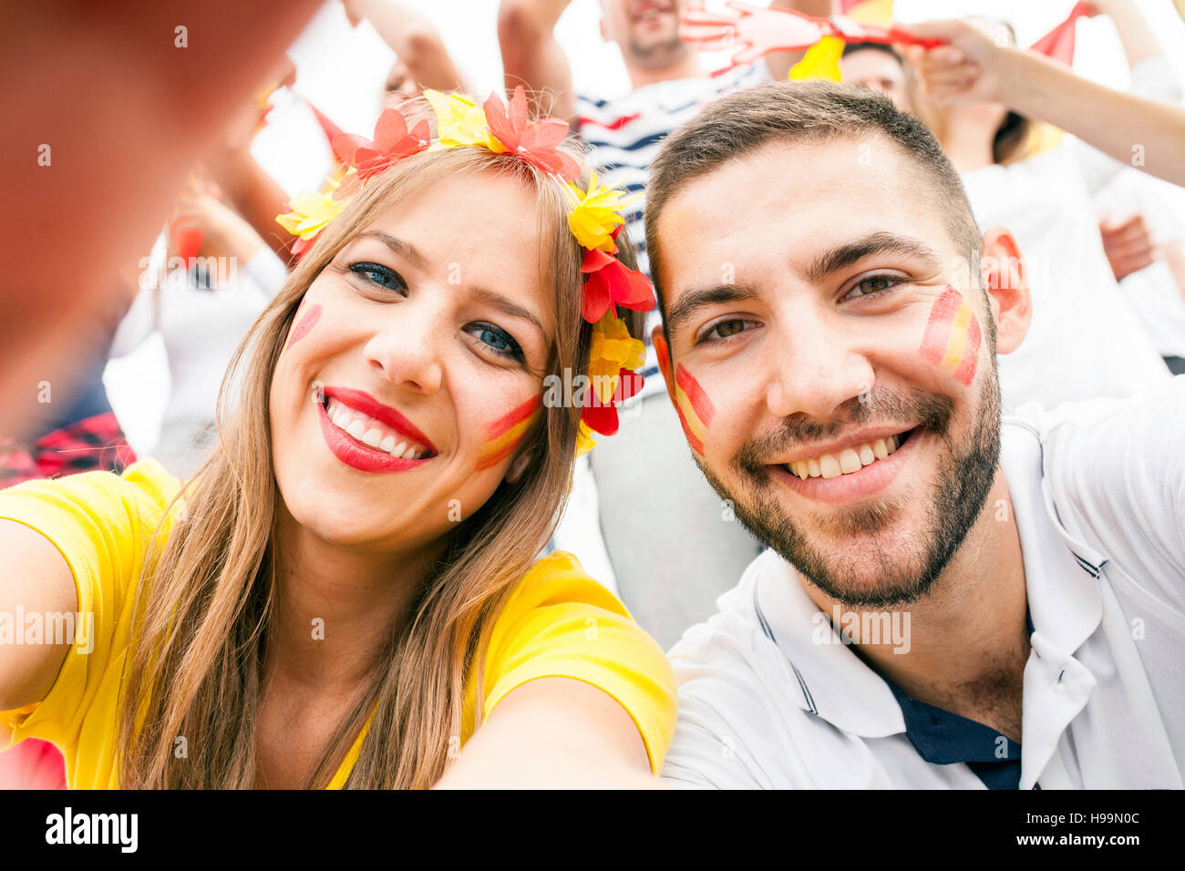 Portrait of Spanish soccer fans with face paint Stock Photo - Alamy