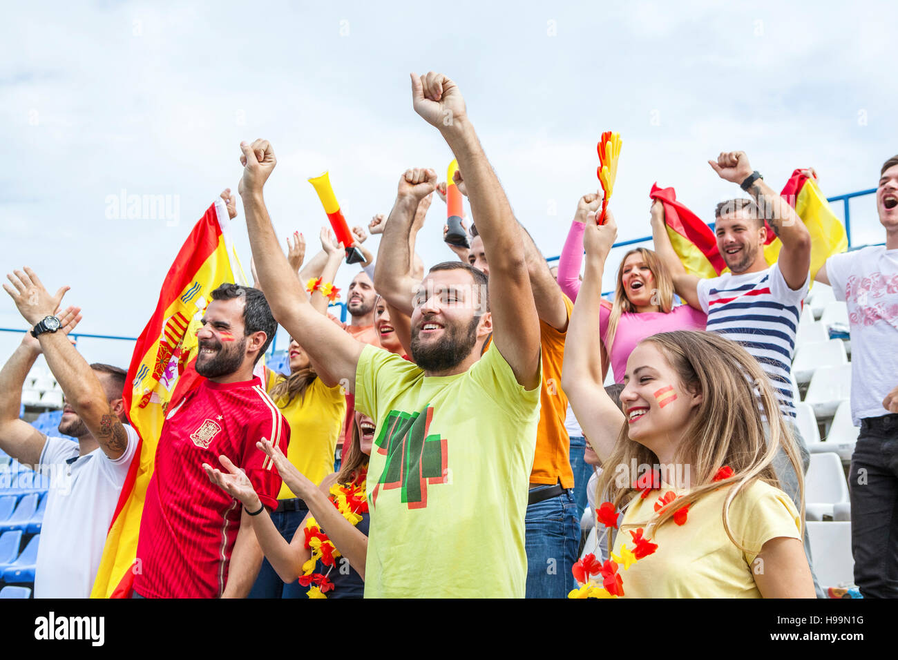 Group of soccer fans shouting in stadium Stock Photo - Alamy
