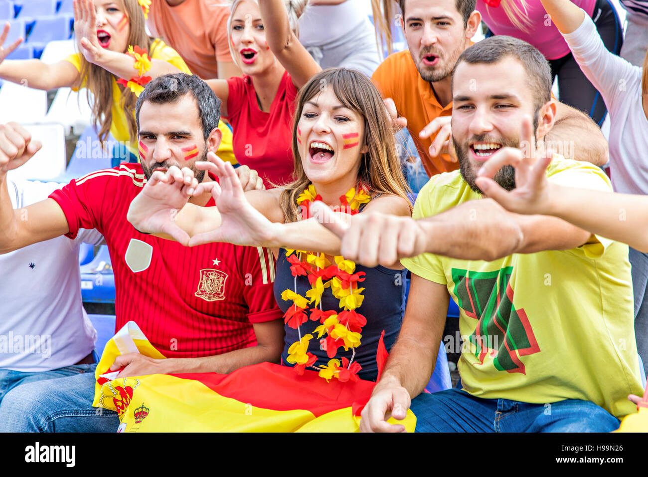 Group of soccer fans shouting in stadium Stock Photo - Alamy