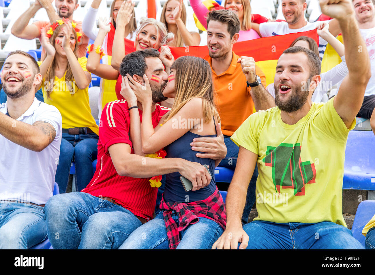Young couple in stadium kissing Stock Photo - Alamy
